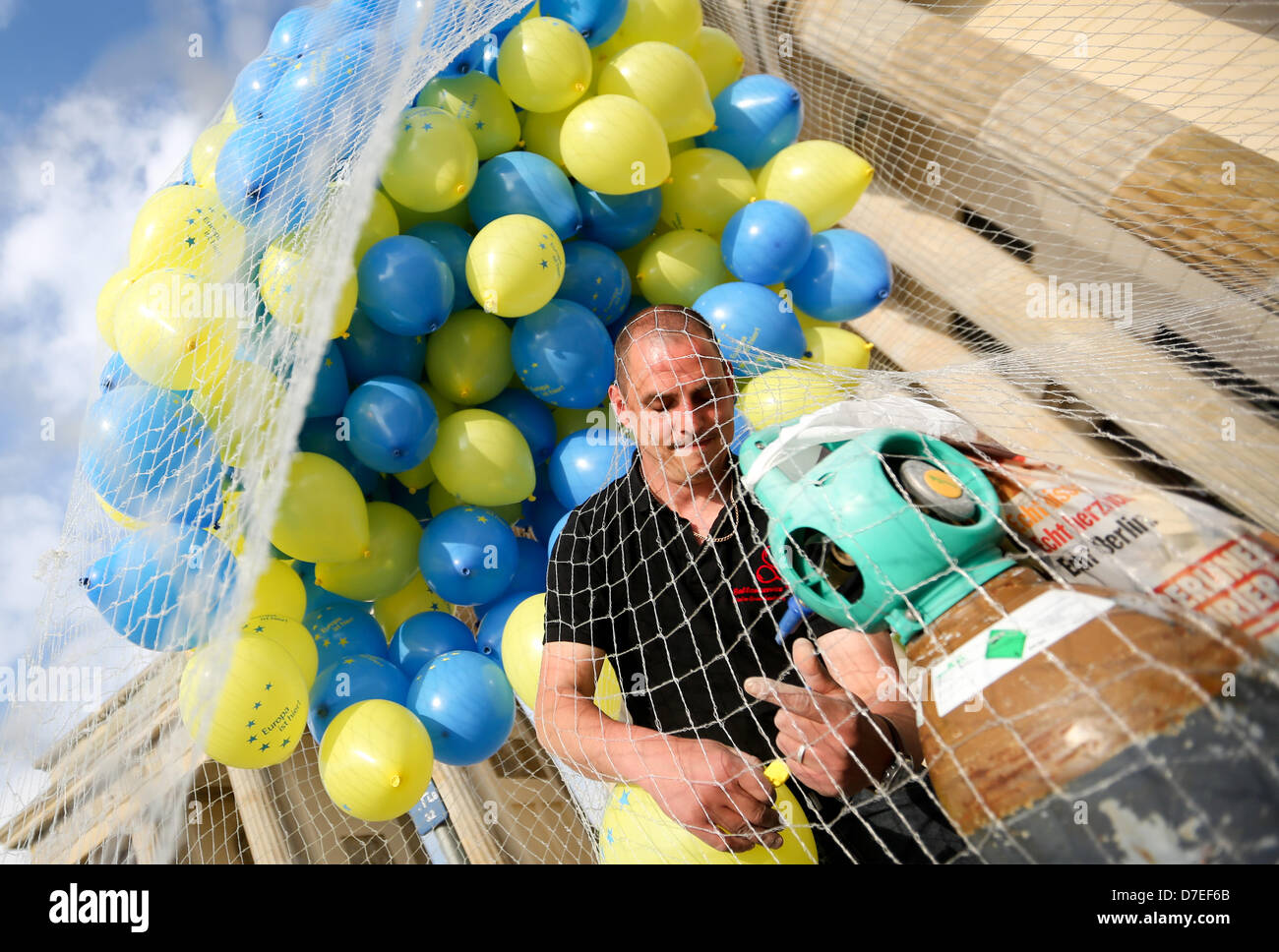 Martin Mogk inflates balloons lettered 'Eurpoe is here' at the Europe ...