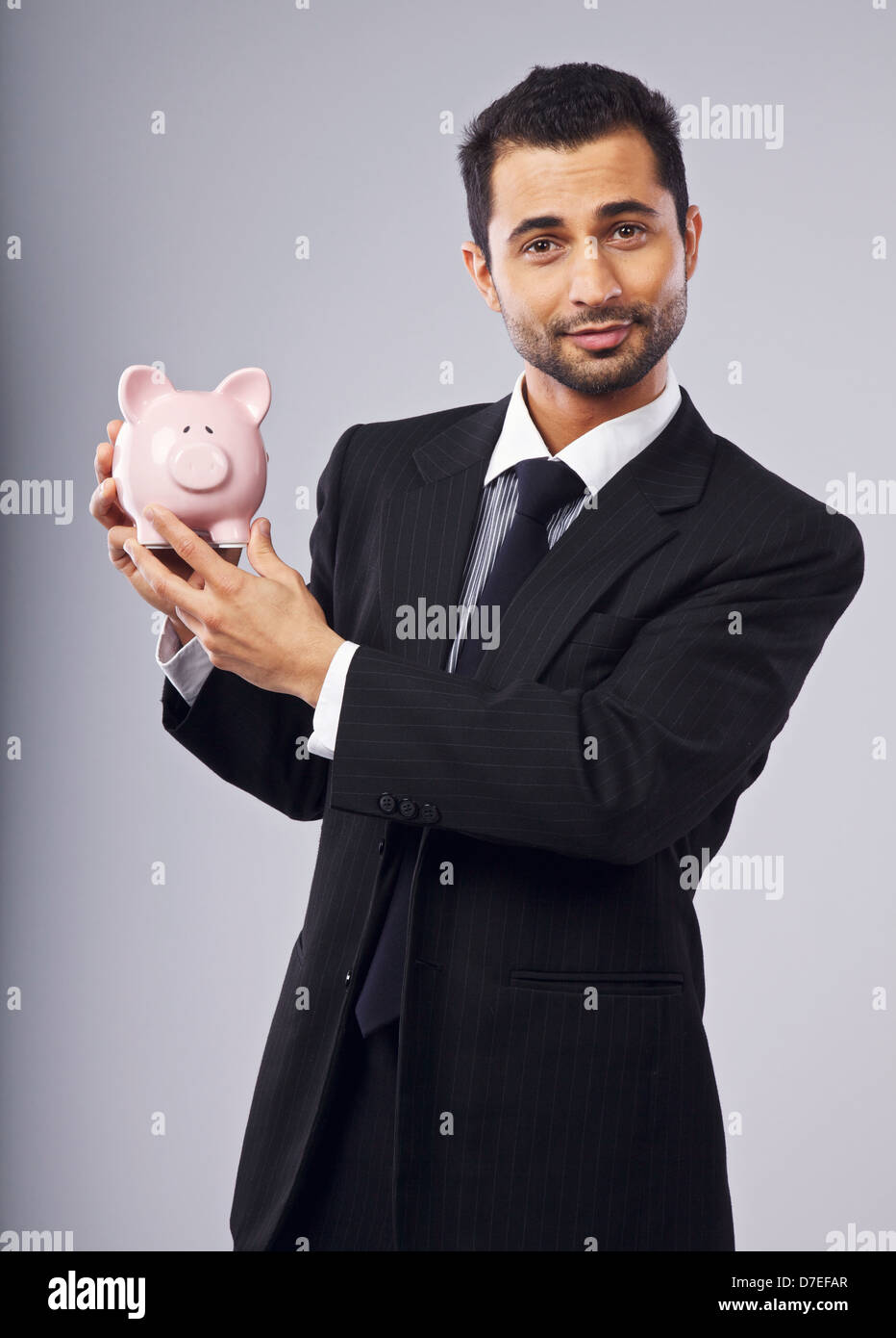 Cheerful Executive Showing You A Piggy Bank Stock Photo - Alamy