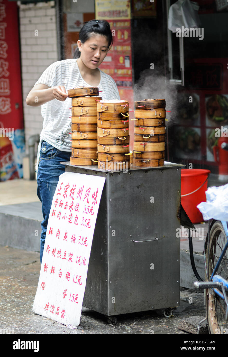 Chinese lady piling up the dim sum early in the morning. Scenes such as ...