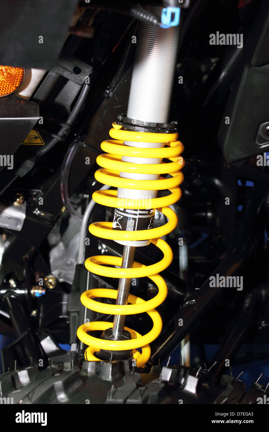 Yellow shock absorber of a quad bike Stock Photo - Alamy