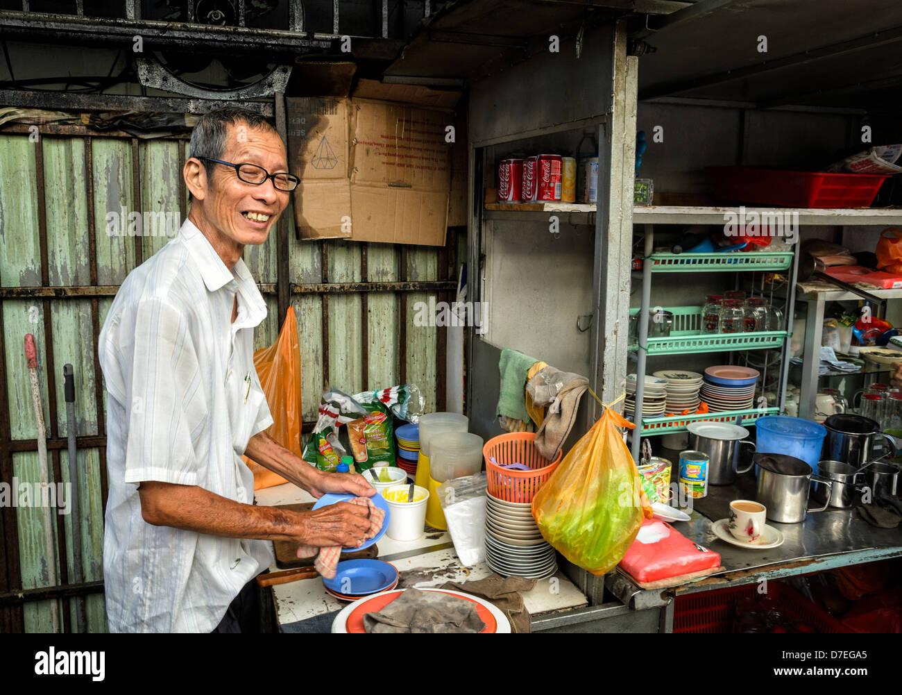 Coffee seller washing dishes at his market stall - actually a mobile ...