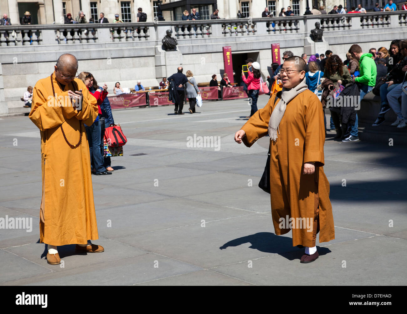 Two Monks Visiting Trafalgar Square in London UK Stock Photo - Alamy