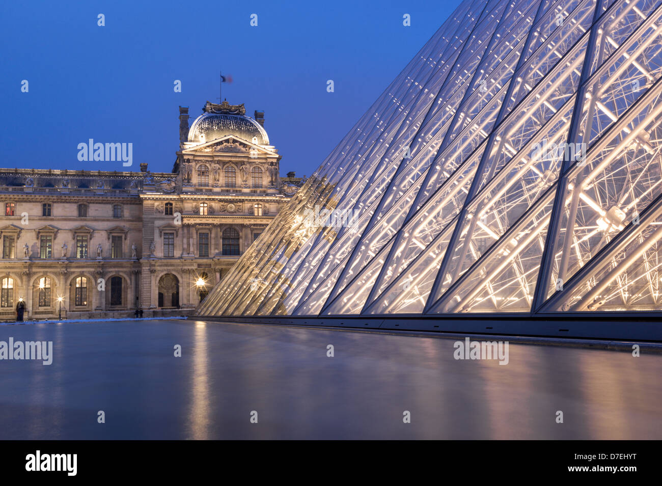 Louvre Museum and the Pyramid at night time in Paris Stock Photo - Alamy