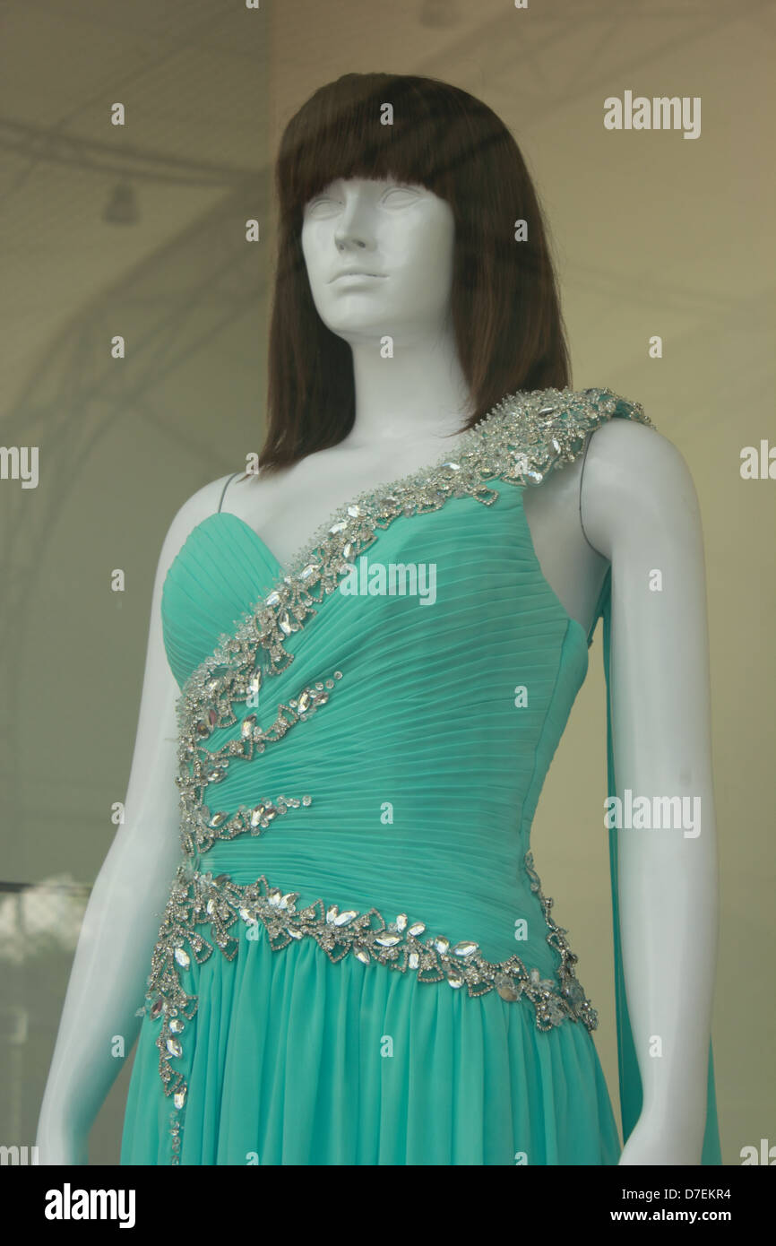 A display of fashion mannequin in clothing and accessories shop window ...