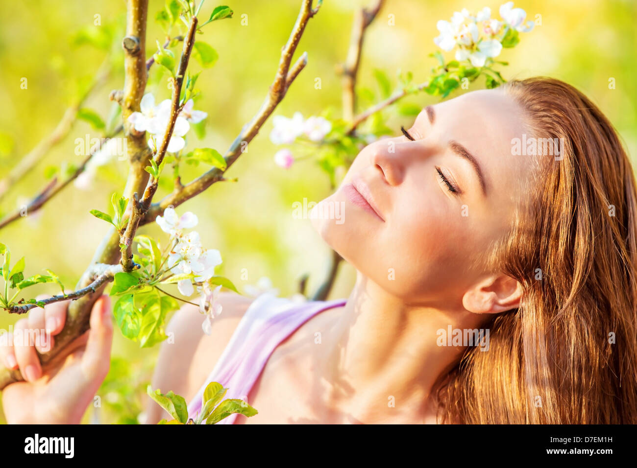 Closeup portrait of beautiful calm woman enjoying spring nature with ...