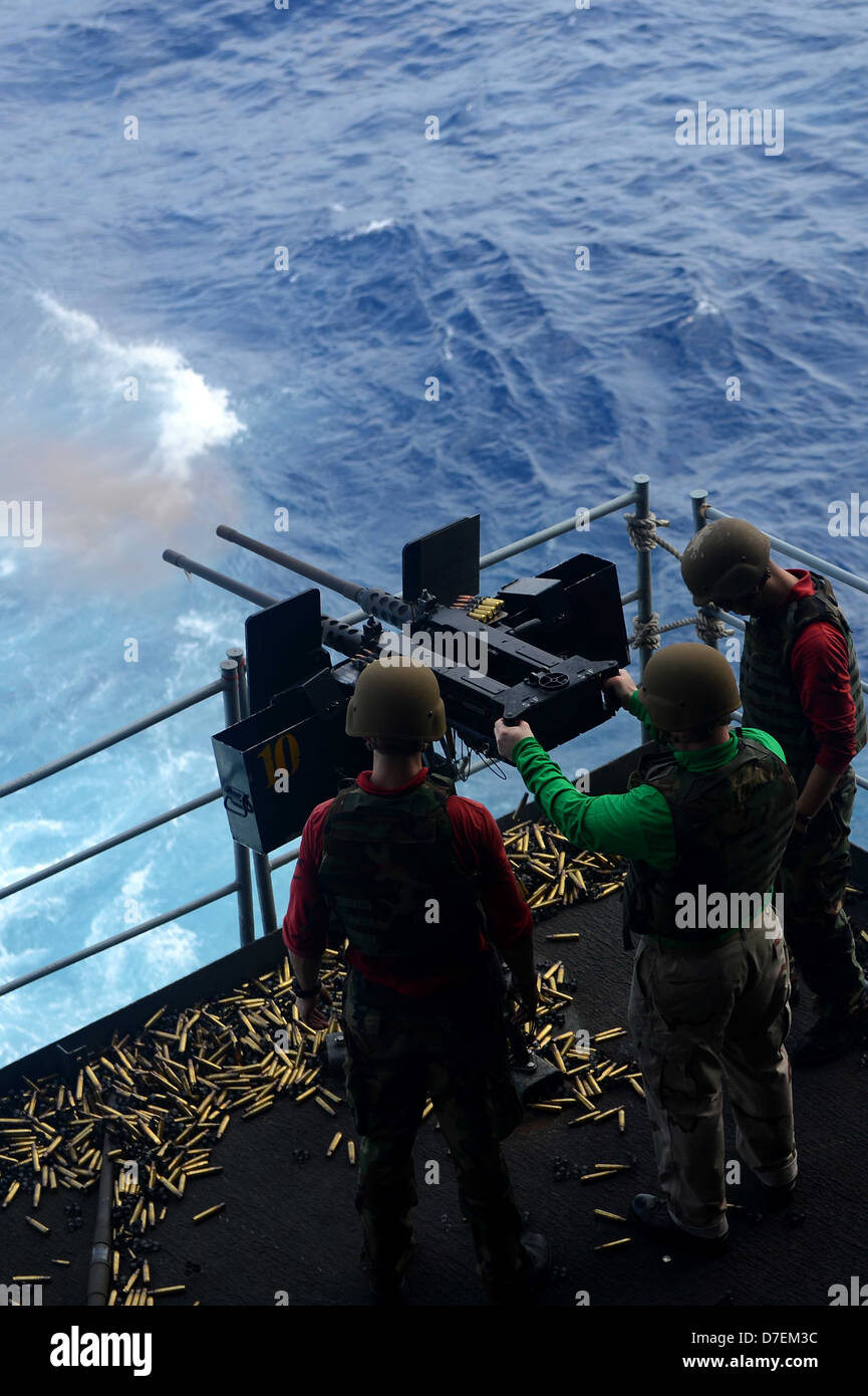 Sailors fire a machine gun at sea Stock Photo - Alamy
