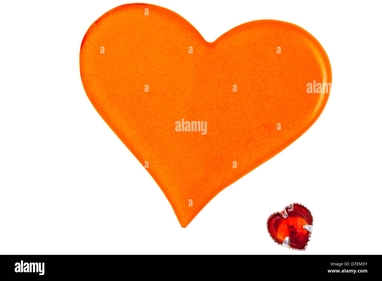 big red plastic heart and small red stone heart isolated on white ...