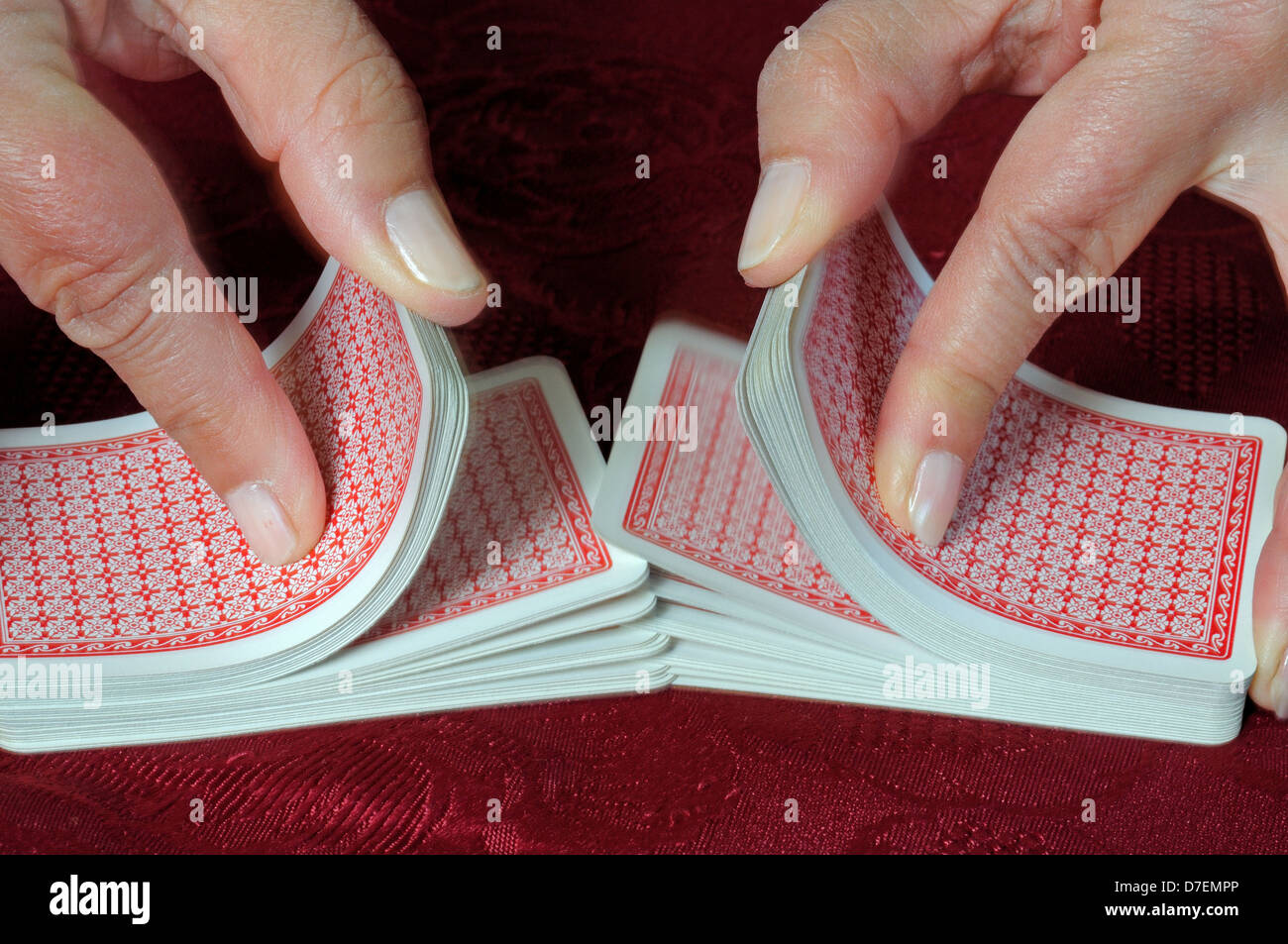 Hands riffle shuffling a pack of playing cards Stock Photo - Alamy