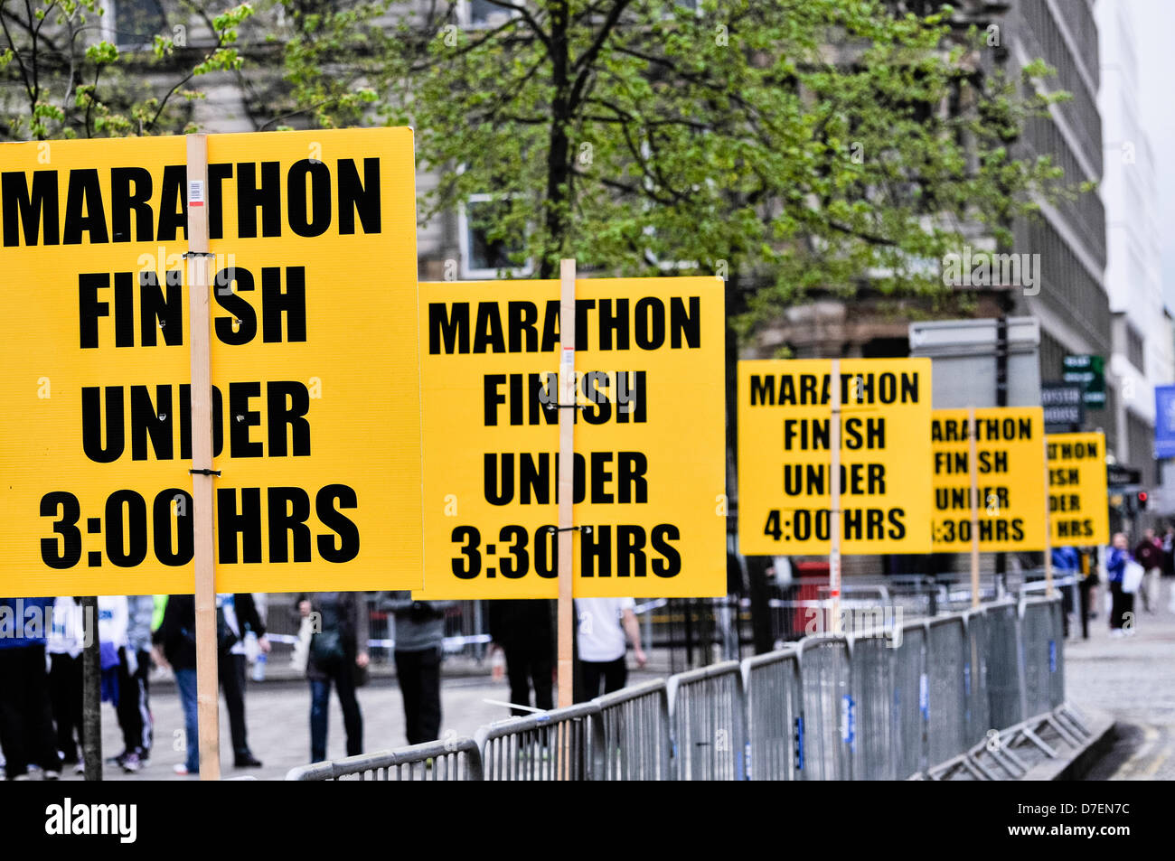 Signs indicate where runners should position themselves at the start of ...