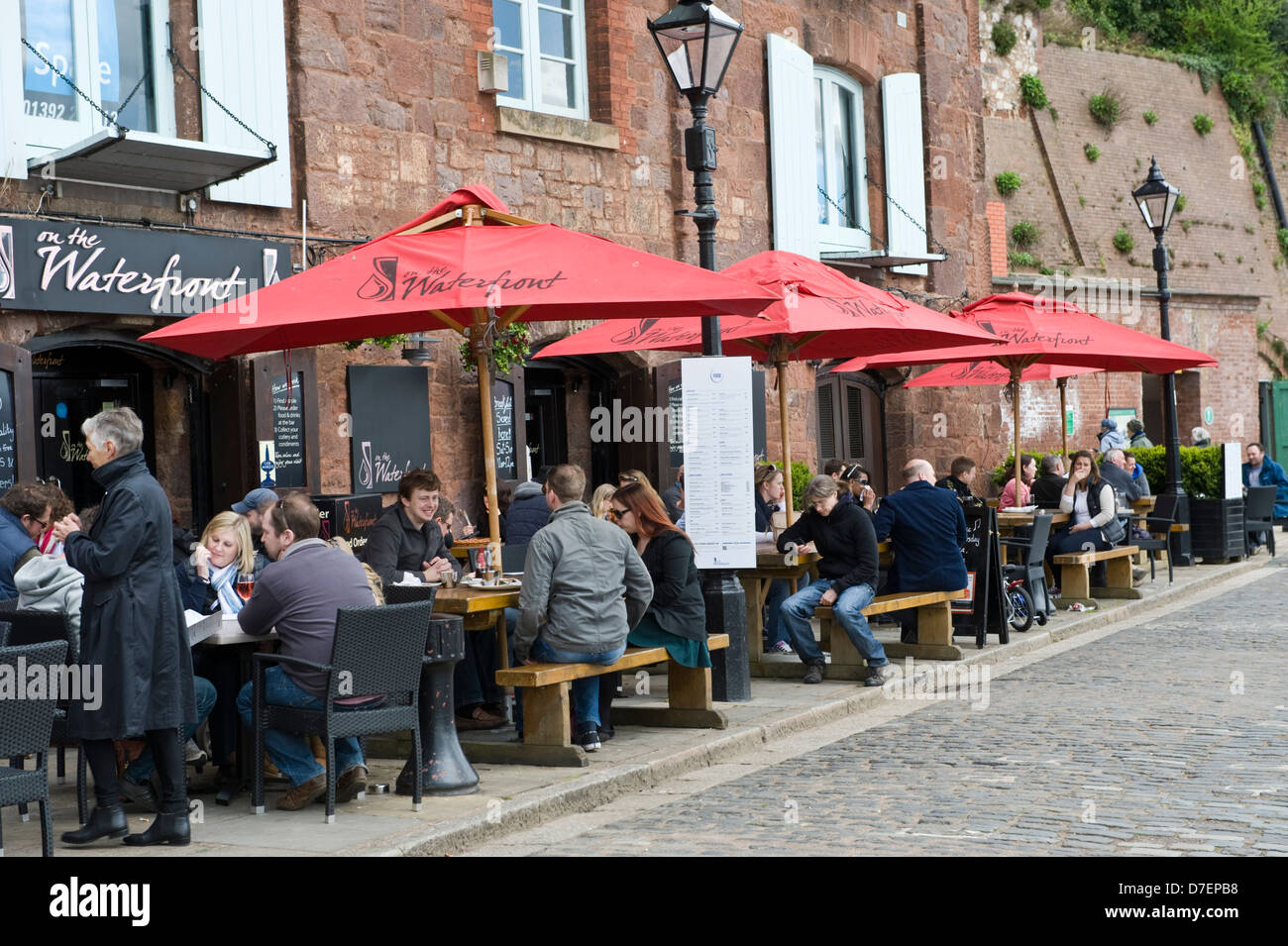 Waterfront diners under umbrellas on the Quayside at Exeter Devon ...