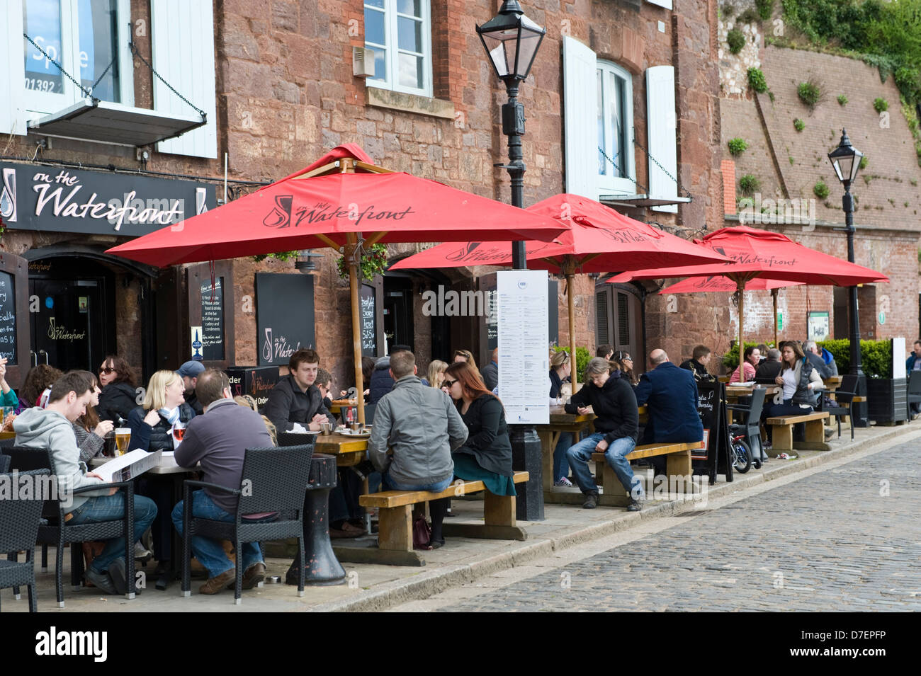 Waterfront diners under umbrellas on the Quayside at Exeter Devon ...