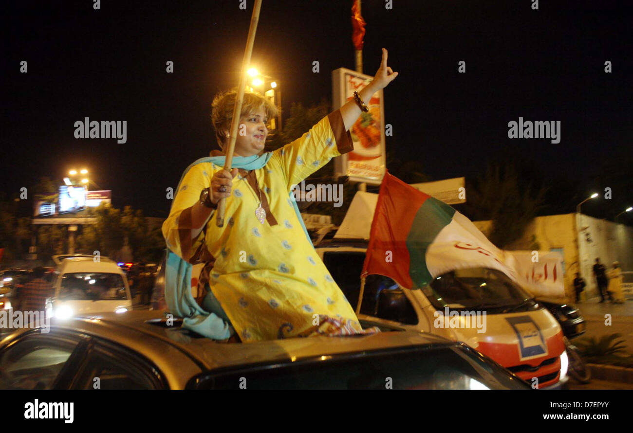 Activists of Muttahida Qaumi Movement (MQM) pass through a road during ...