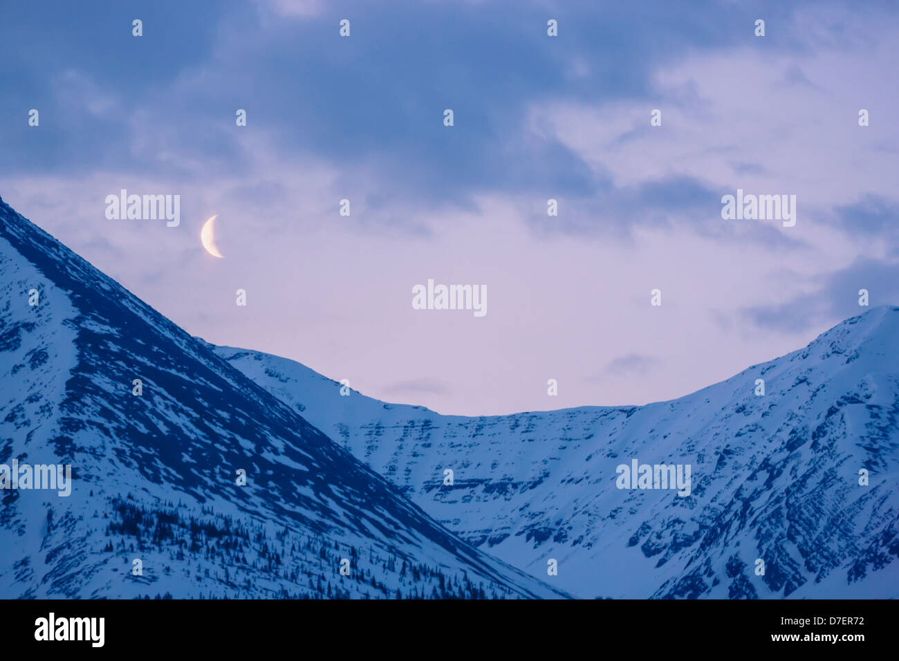 The crescent moon sets above the sentinal range along the alaska ...