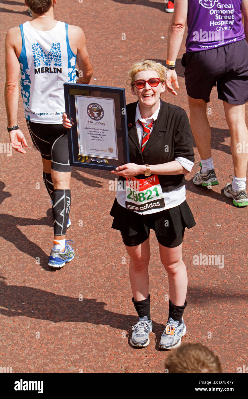 A london Marathon runner dressed as a school girl with her Guinness ...