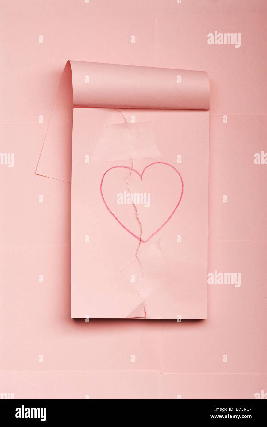 Notepad with hand drawn heart ripped and mended with scotch tape Stock ...