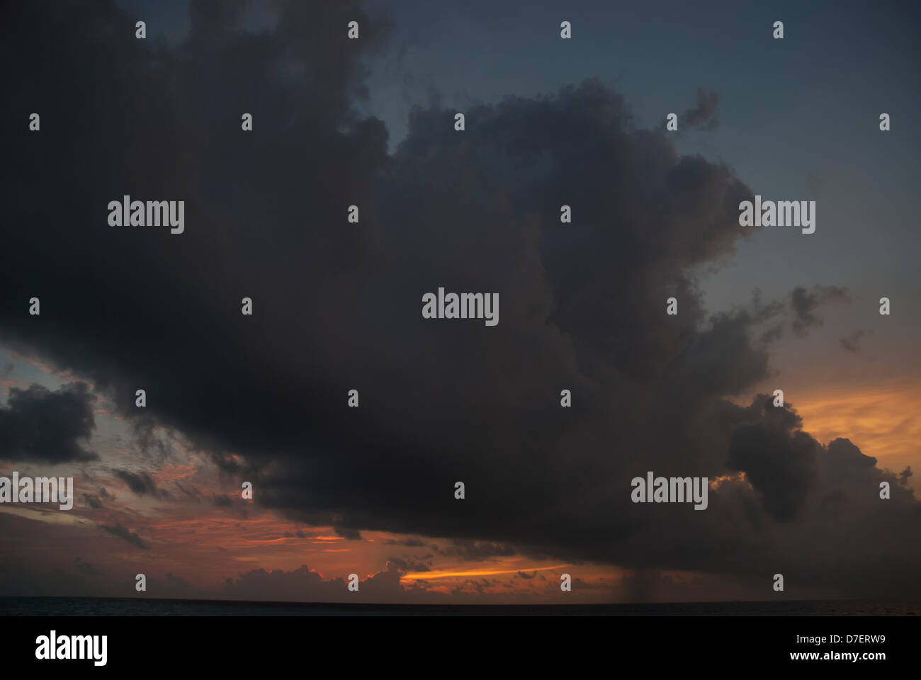 Rain cloud during a stormy sunset;Ranveli island south ari atoll ...