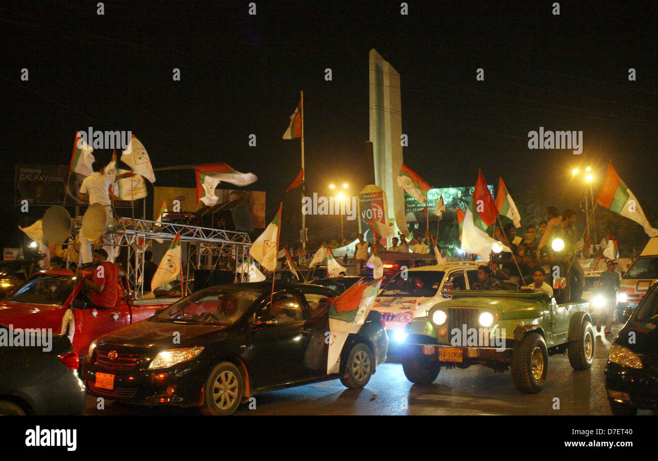 Activists of Muttahida Qaumi Movement (MQM) pass through a road during ...
