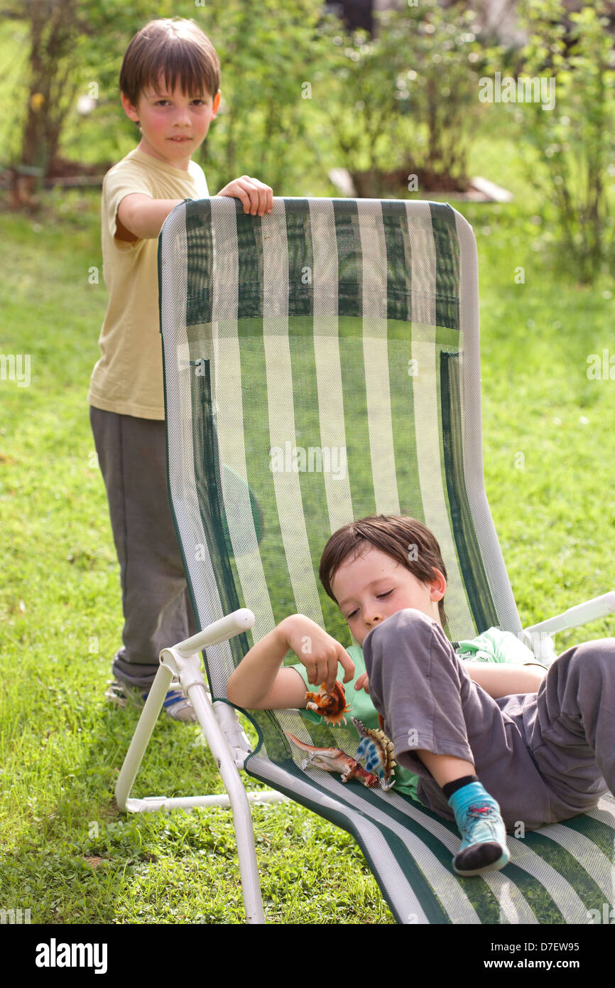 Boys playing outdoor in the garden Stock Photo - Alamy