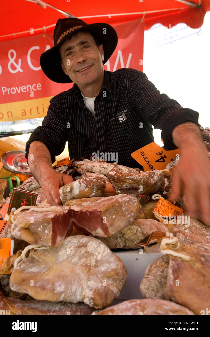 A butcher at his stall at a village carnival in Roujan,languedoc,france ...