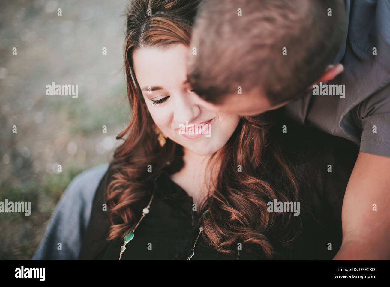 A man bending over to kiss a woman on the cheek;White rock british ...