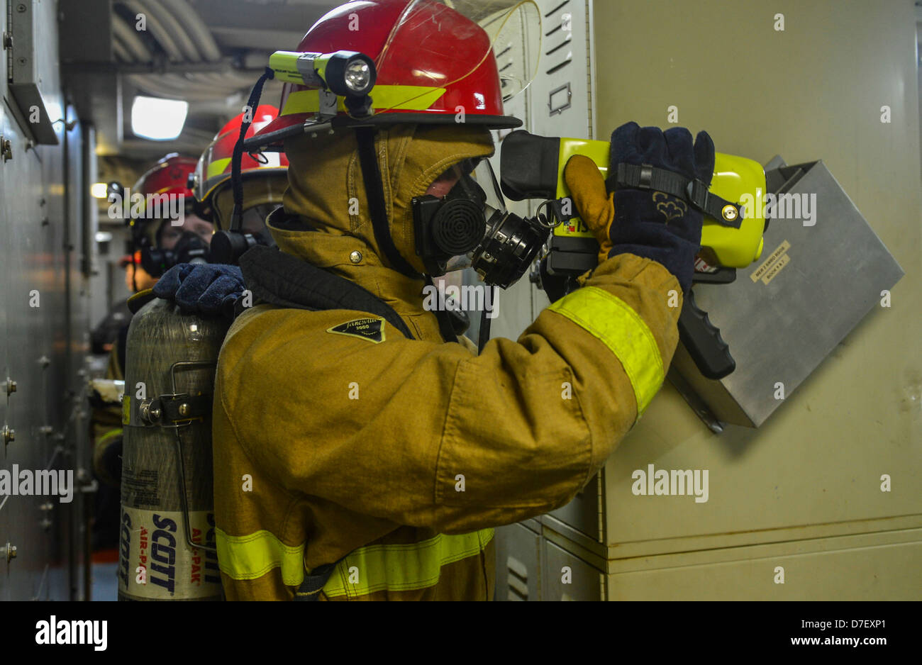A firefighter looks for hot spots Stock Photo - Alamy