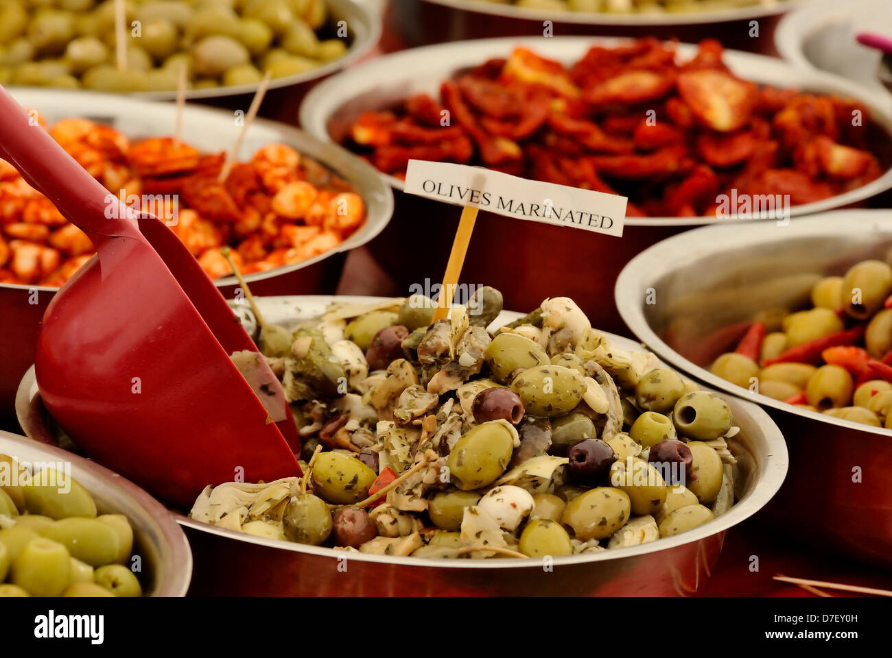A table with many different types of olives on display with the focus ...