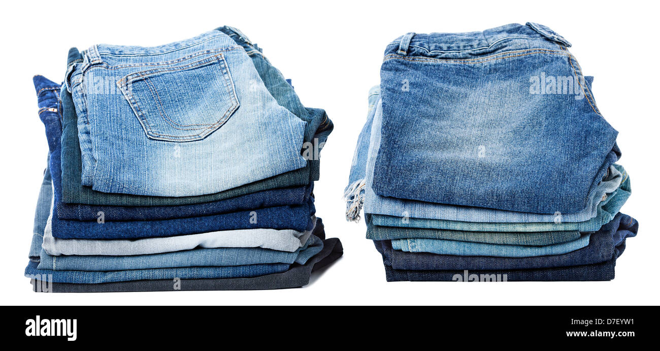 Two stacks of various pairs of jeans pants isolated on white background ...