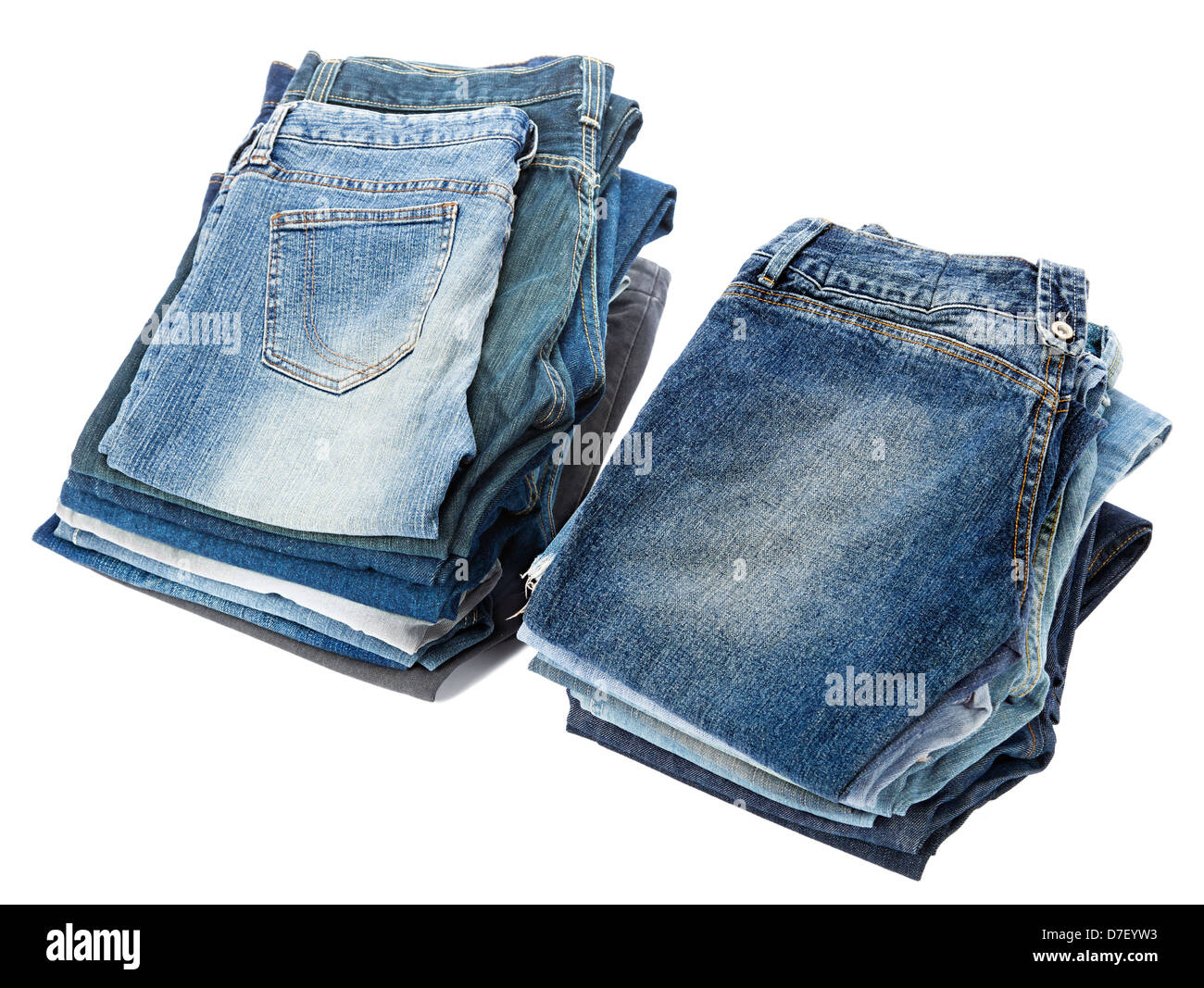 Two stacks of various pairs of jeans pants isolated on white background ...