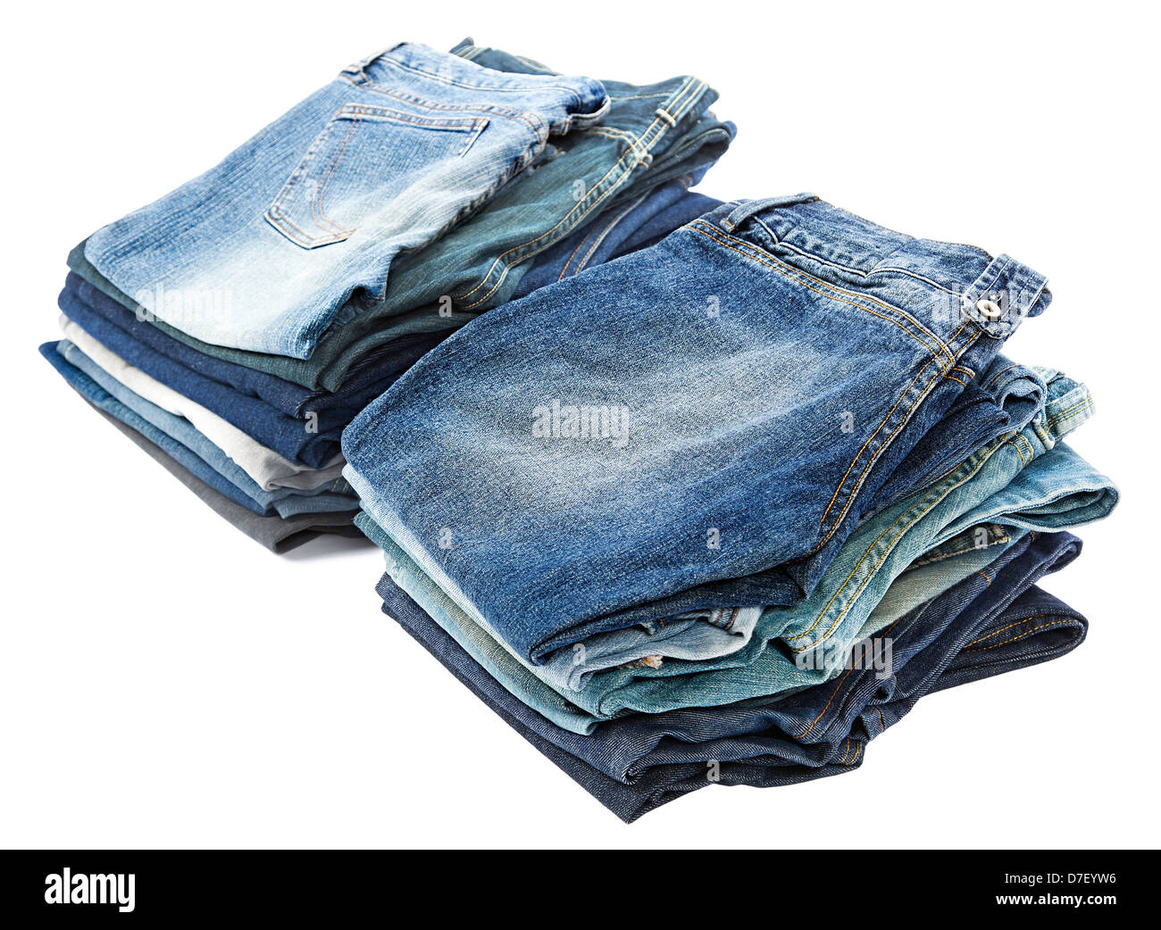 Two stacks of various pairs of jeans pants isolated on white background ...