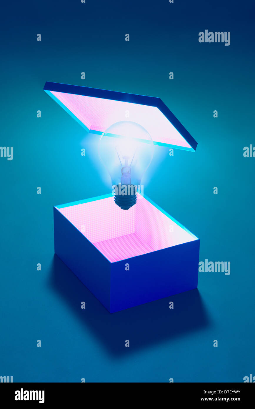 Conceptual photo of an illuminated box with a lightbulb and floating ...