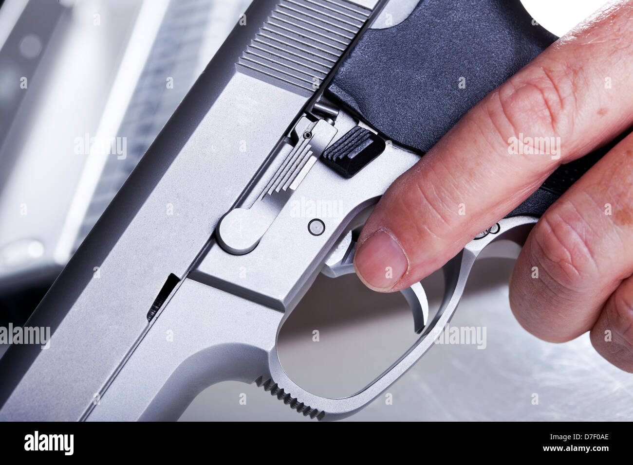 VExtreme close up left hand mature adult man holding 9mm handgun his ...