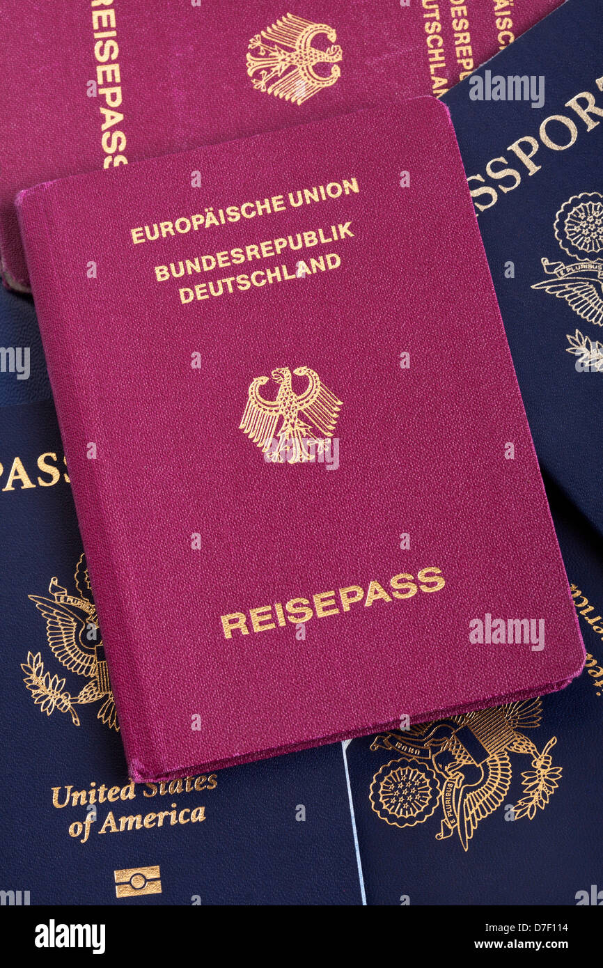 A German passport resting on a stack of American and German passports ...