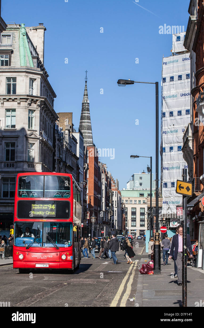 A double-decker bus moving along a street in Central London, England ...