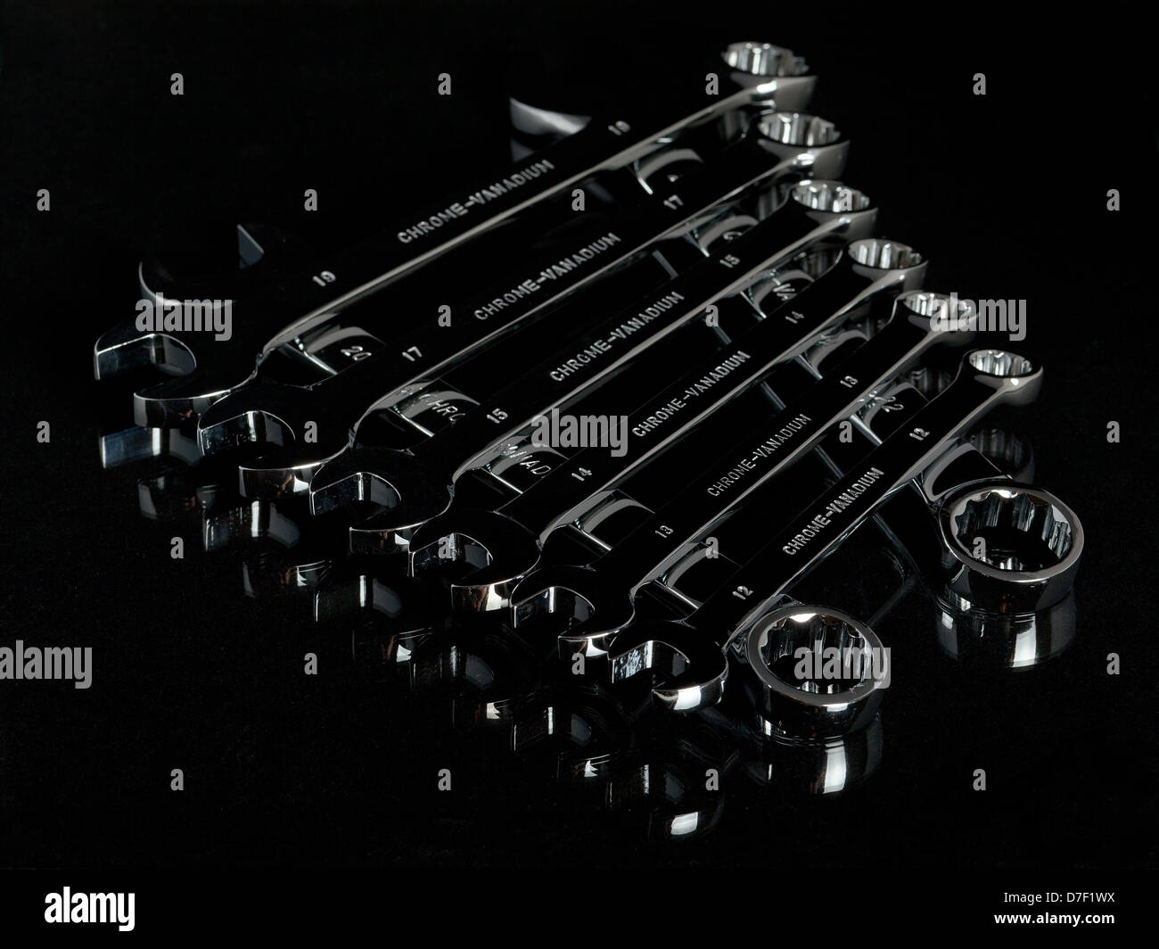 Polished vanadium steel metric spanner set on a shiny black background ...