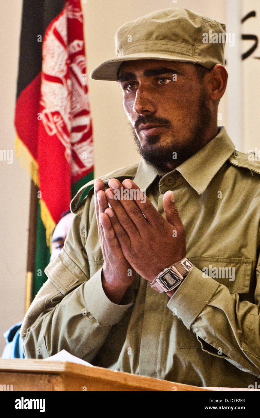 A new Afghan Local Police recruit prays during an shura meeting October ...