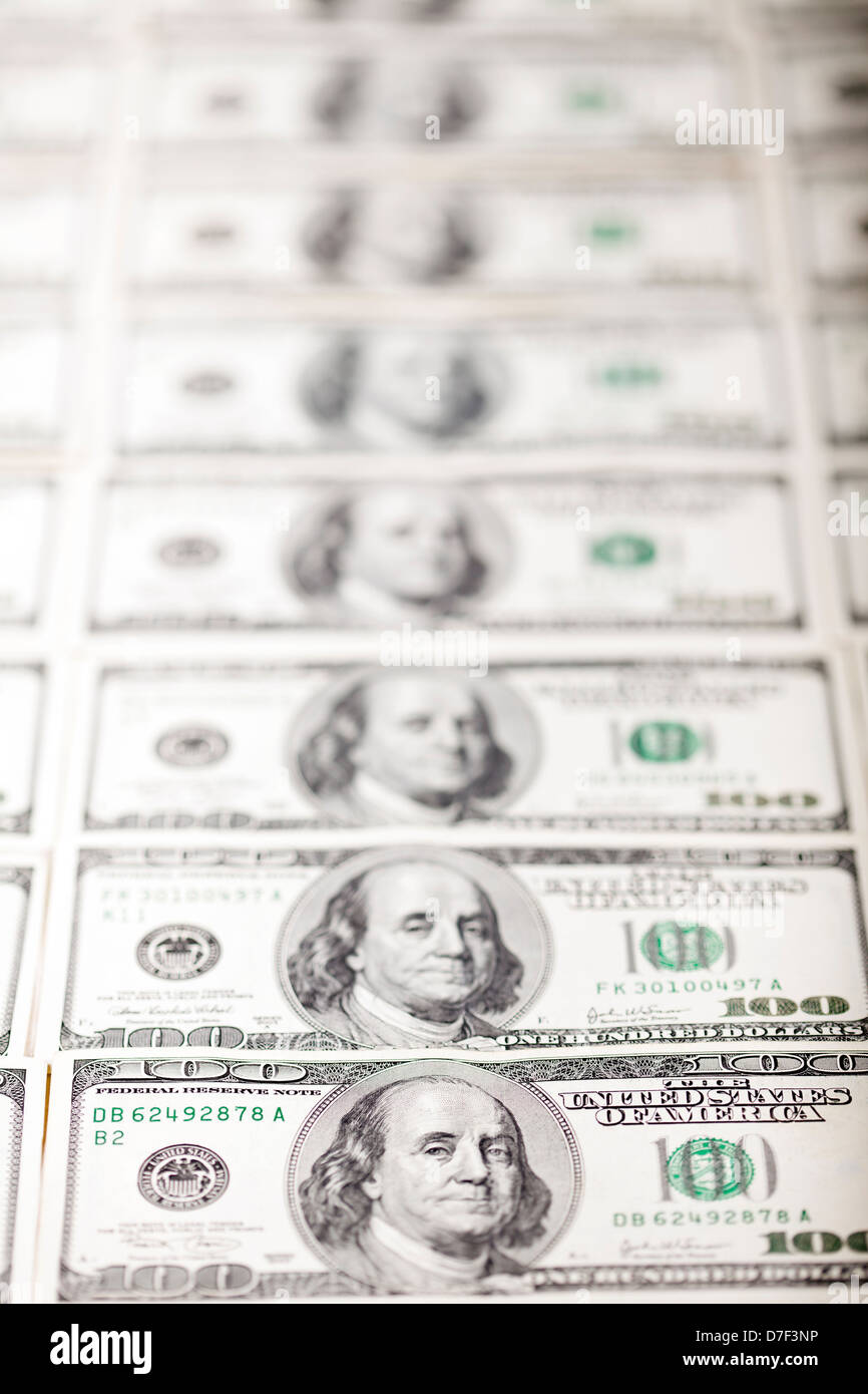 A large quantity of 100 US$ money notes lined up in a vertical row ...