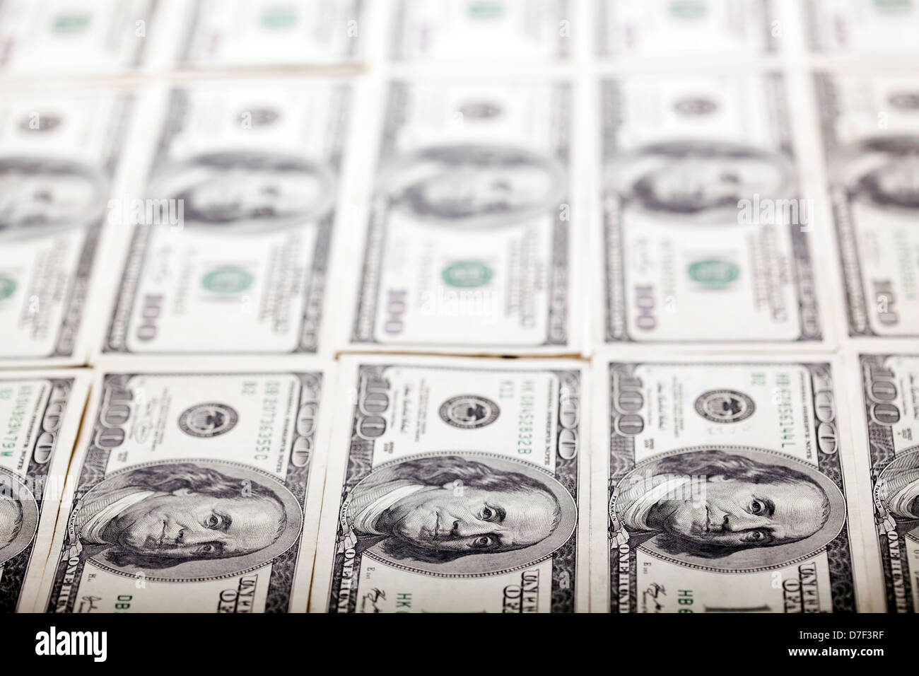 A large quantity of 100 US$ money notes lined up in rows. Very shallow ...