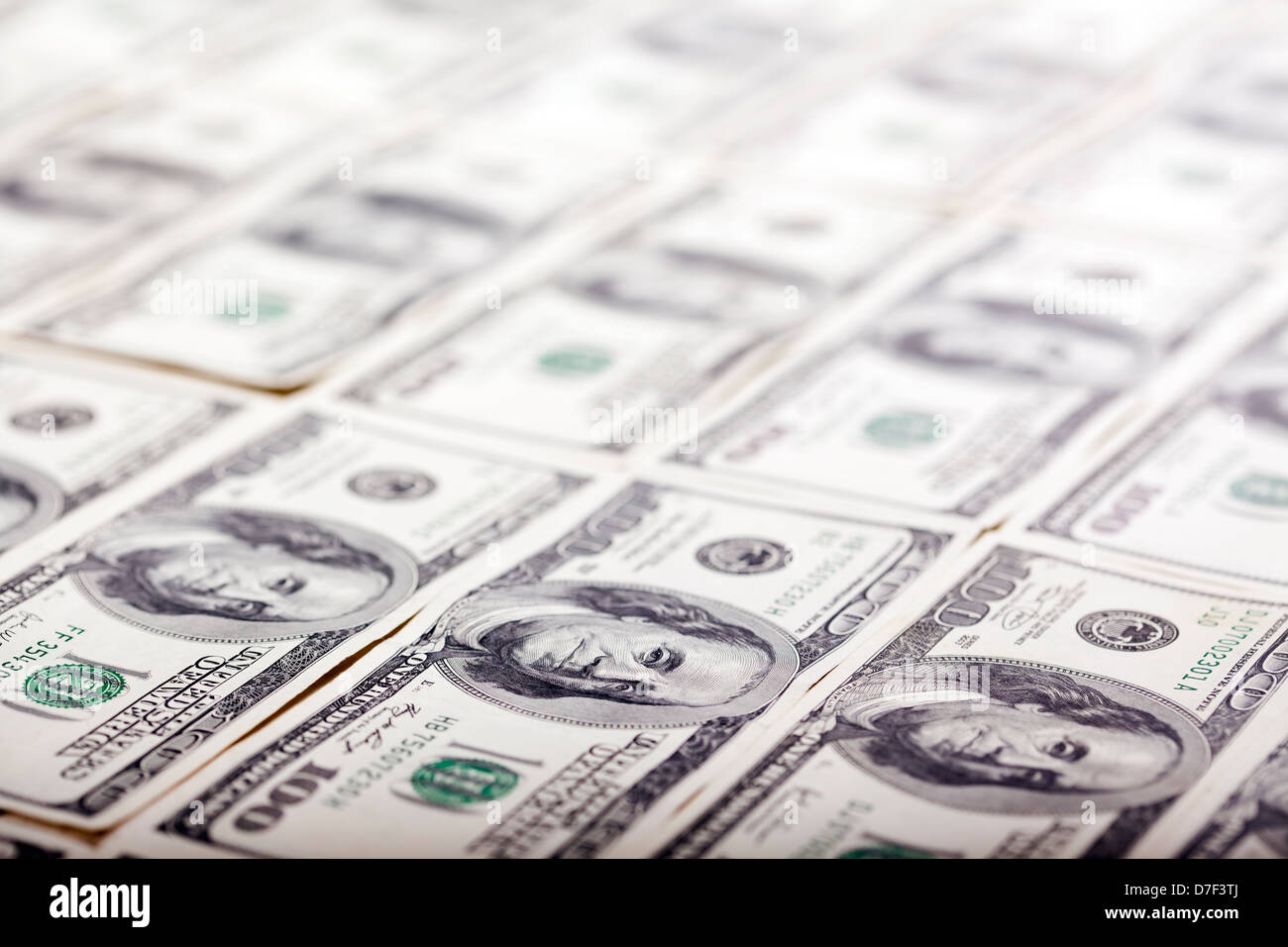 A large quantity of 100 US$ money notes lined up in a vertical row ...