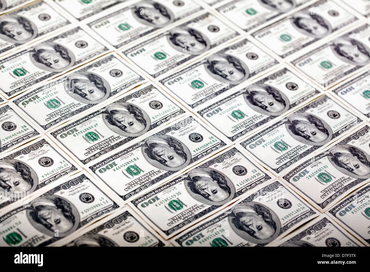 A large quantity of 100 US$ money notes lined up in rows. Shallow depth ...