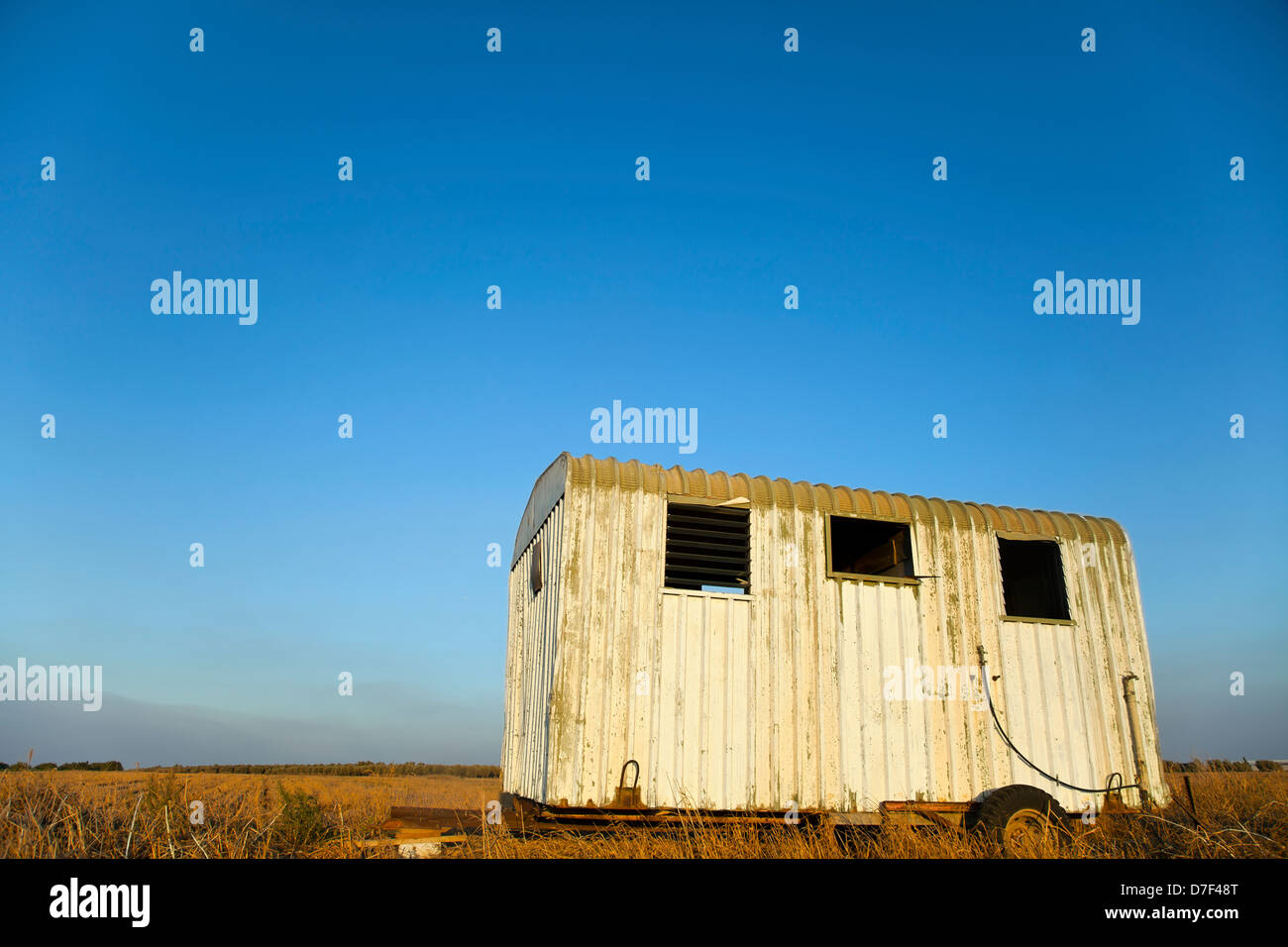A deserted wreck of an old beaten up trailer in the middle of a ...