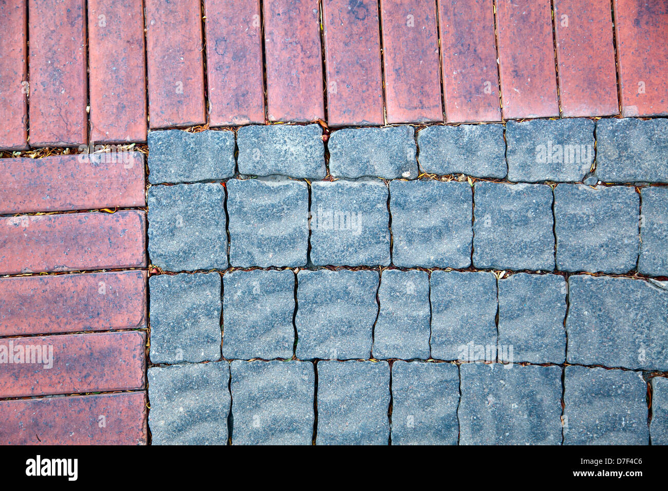 Gray floor tiles with wavy/rippled texture and red bricks lit by ...
