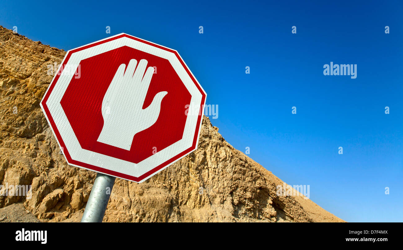 Stop sign on the background of a desert mountain and clear blue sky ...