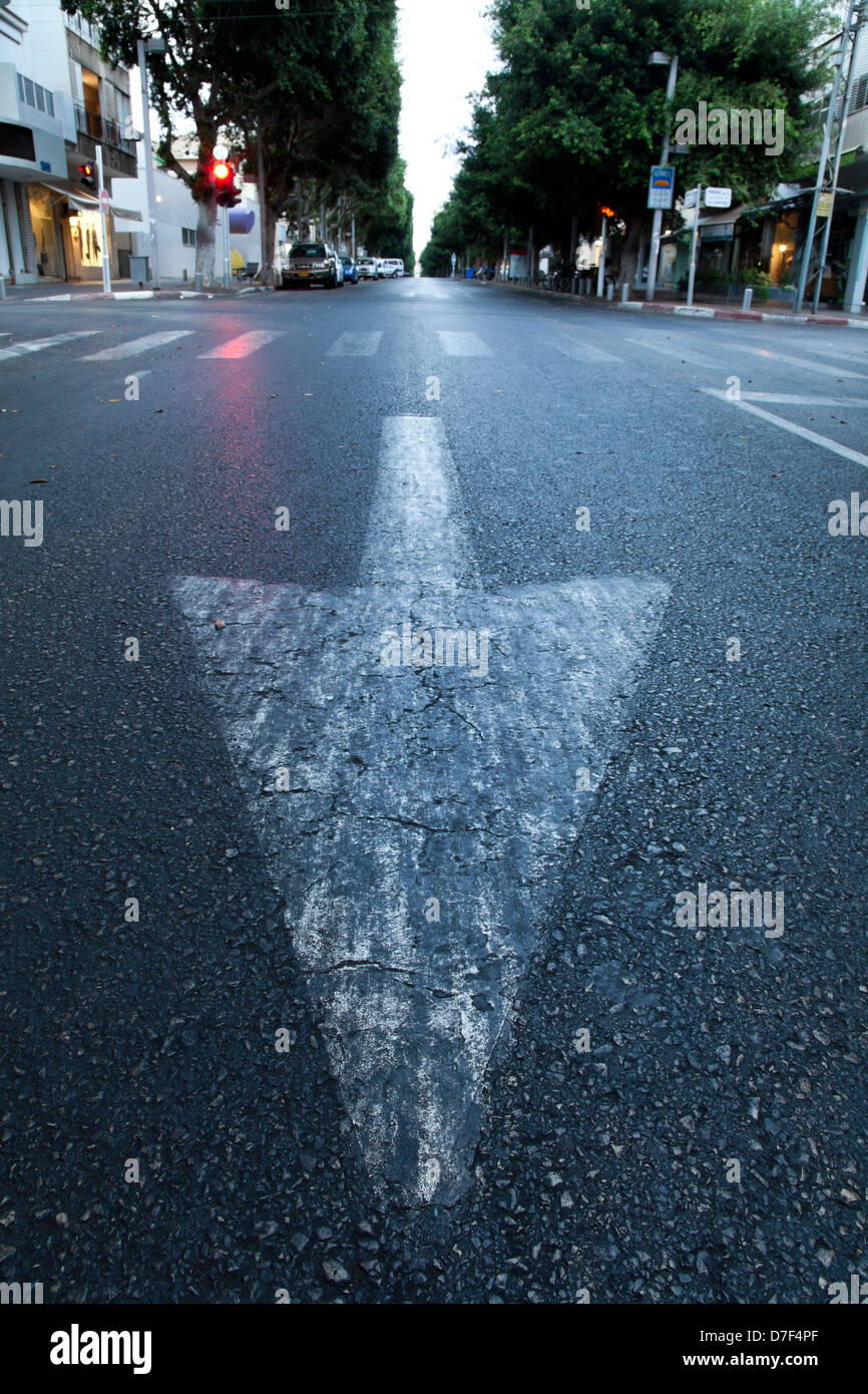 Directional arrow pointing to the camera on an empty street in Tel-Aviv ...