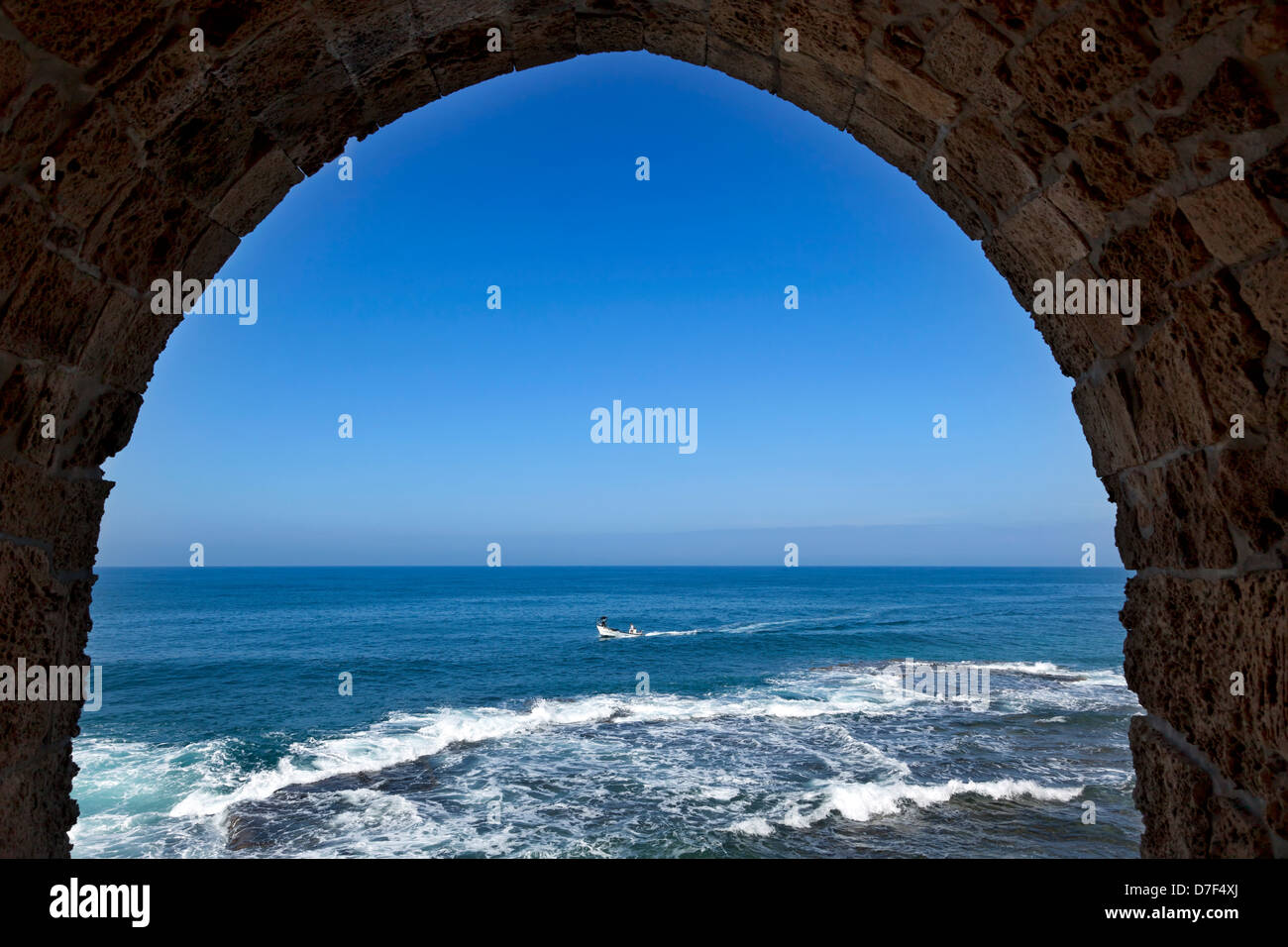 View at Mediterranean sea fisherman's boat from within an arched window ...