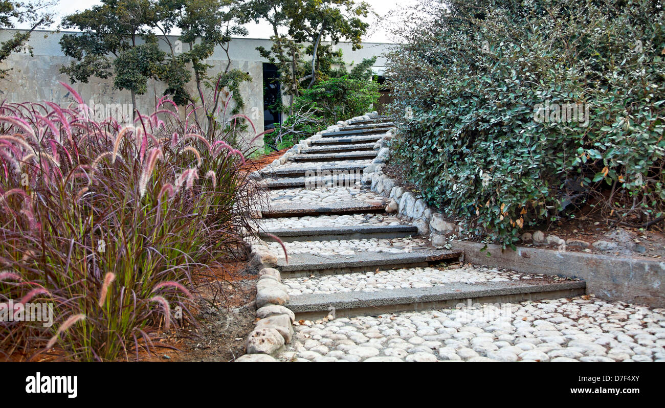 A lovely stone-pebbles paved staircase among the bushes in an urban ...