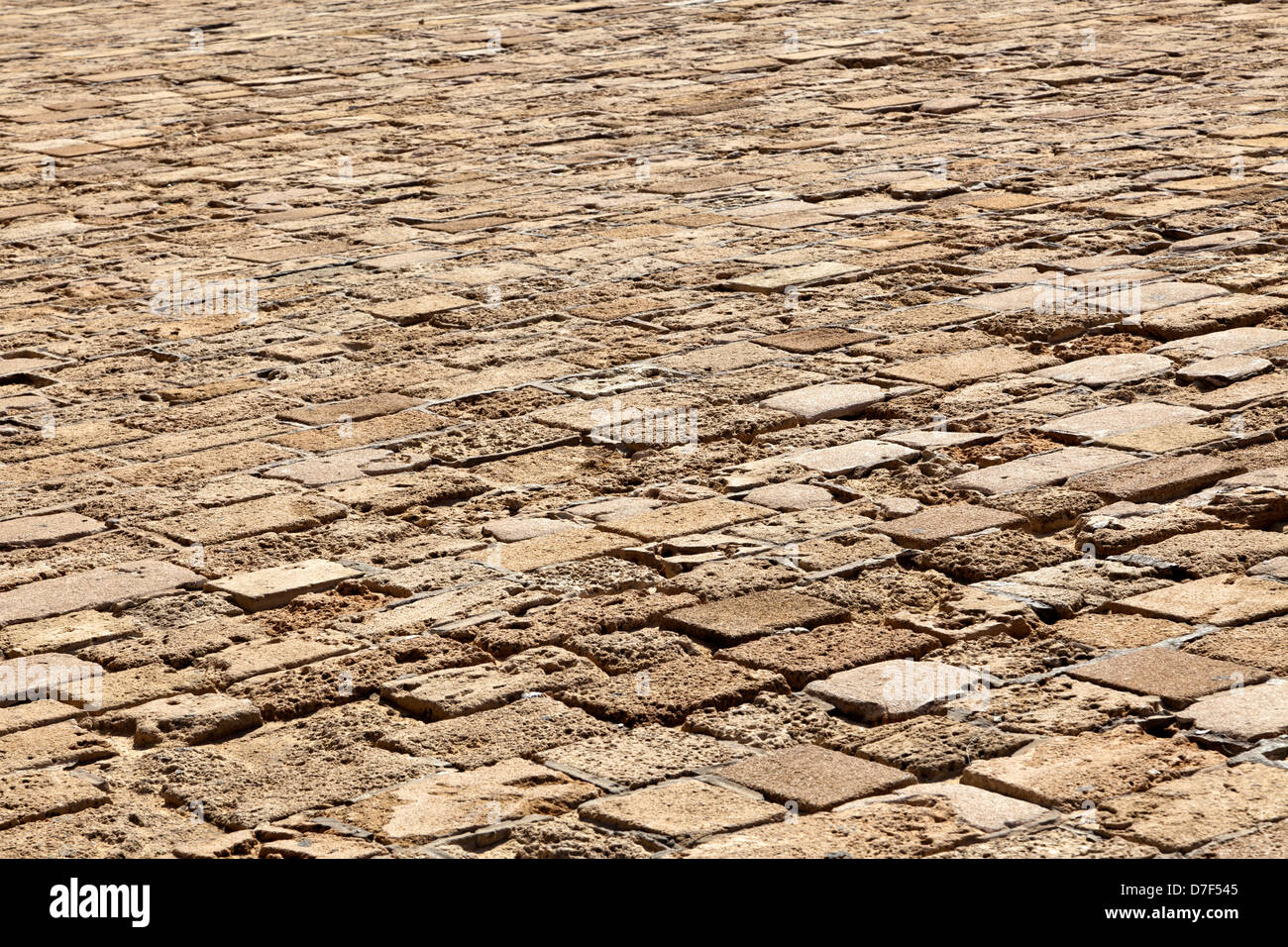 Ancient floor made stone bricks set diagonally to lens shot from slight ...