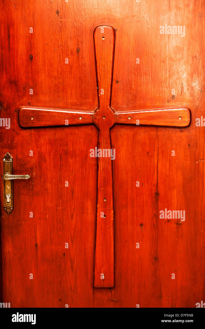 Large relief of a crucifix on a wooden door located in a church Stock ...