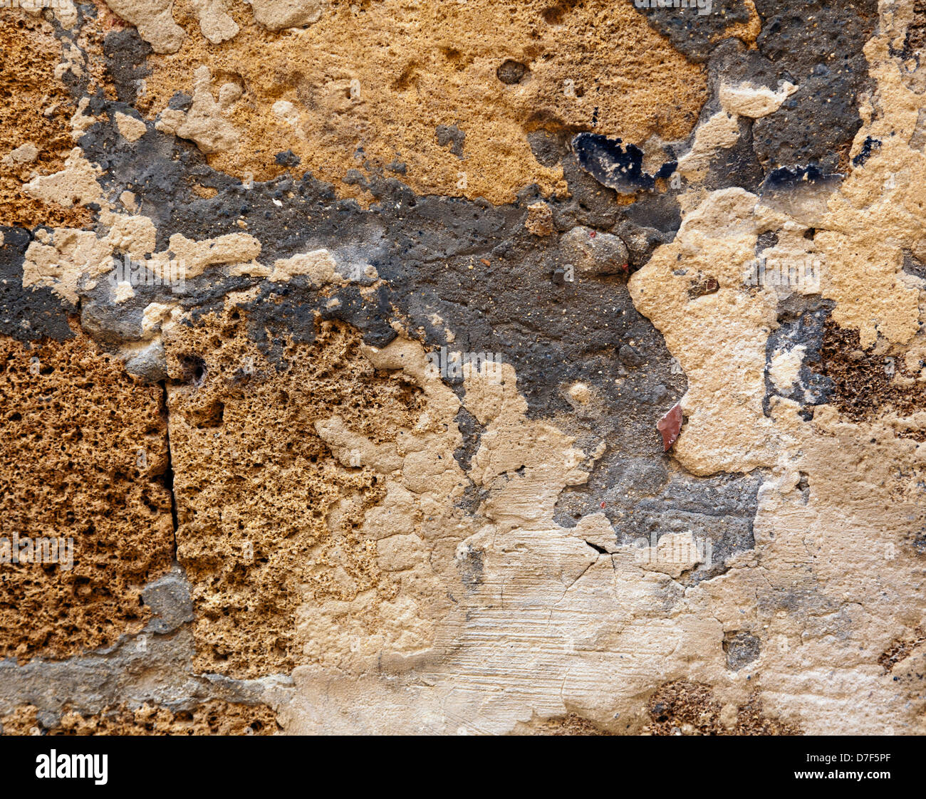 Close up of a wall with all its layers revealed in patches: paint ...