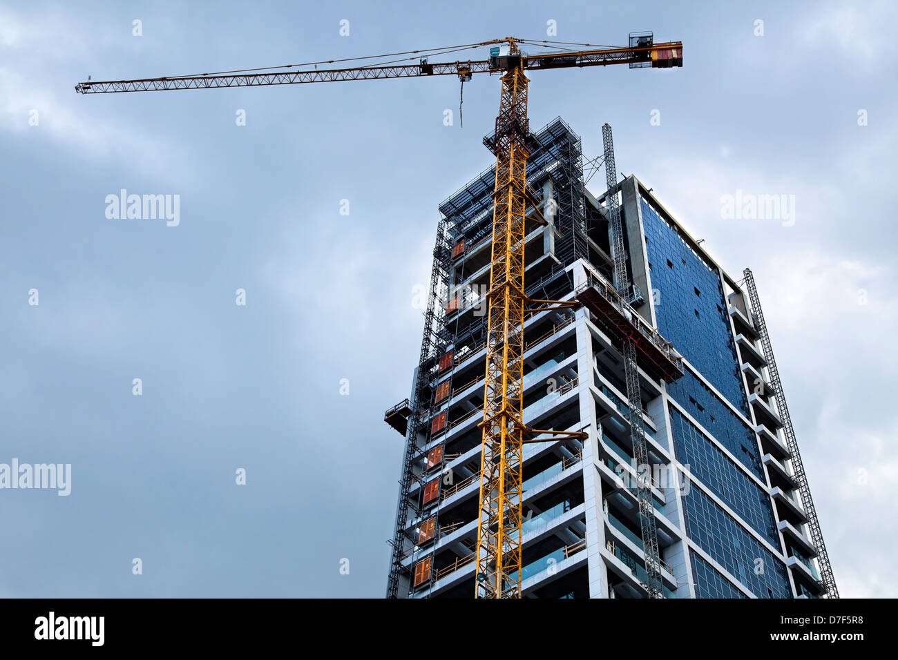 A high rise residential building in the middle of construction, on the ...