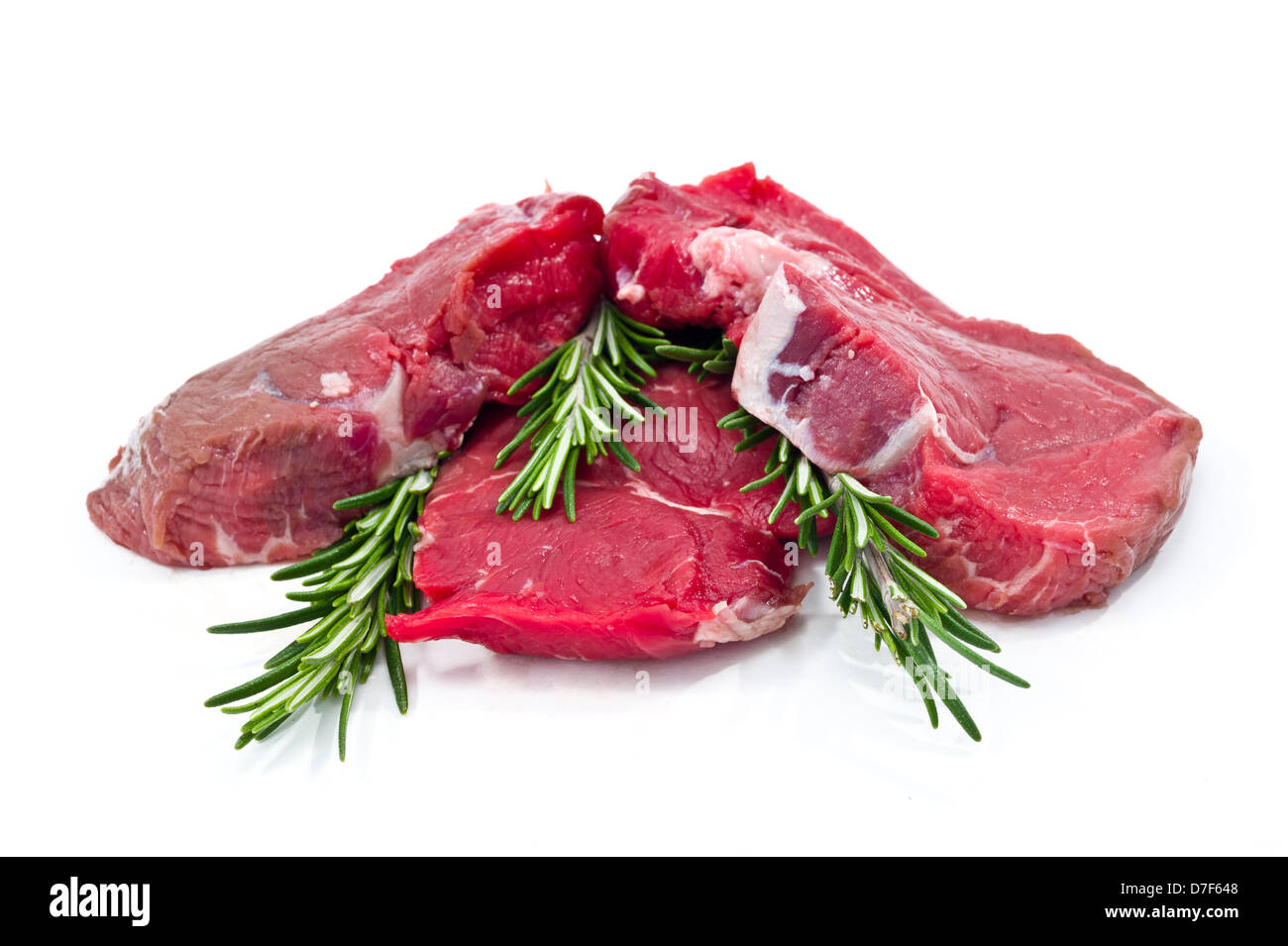 Raw beef with rosemary in white background Stock Photo - Alamy